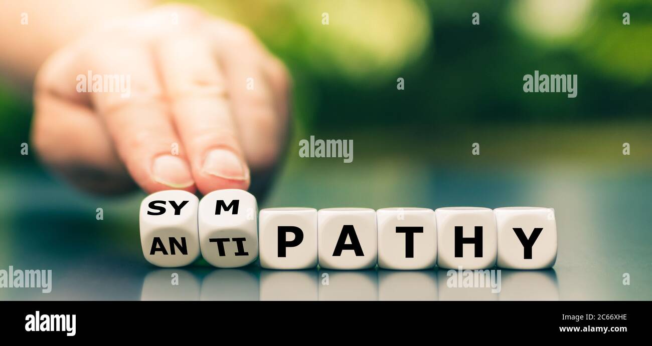 Hand turns dice and changes the word antipathy to sympathy Stock Photo ...