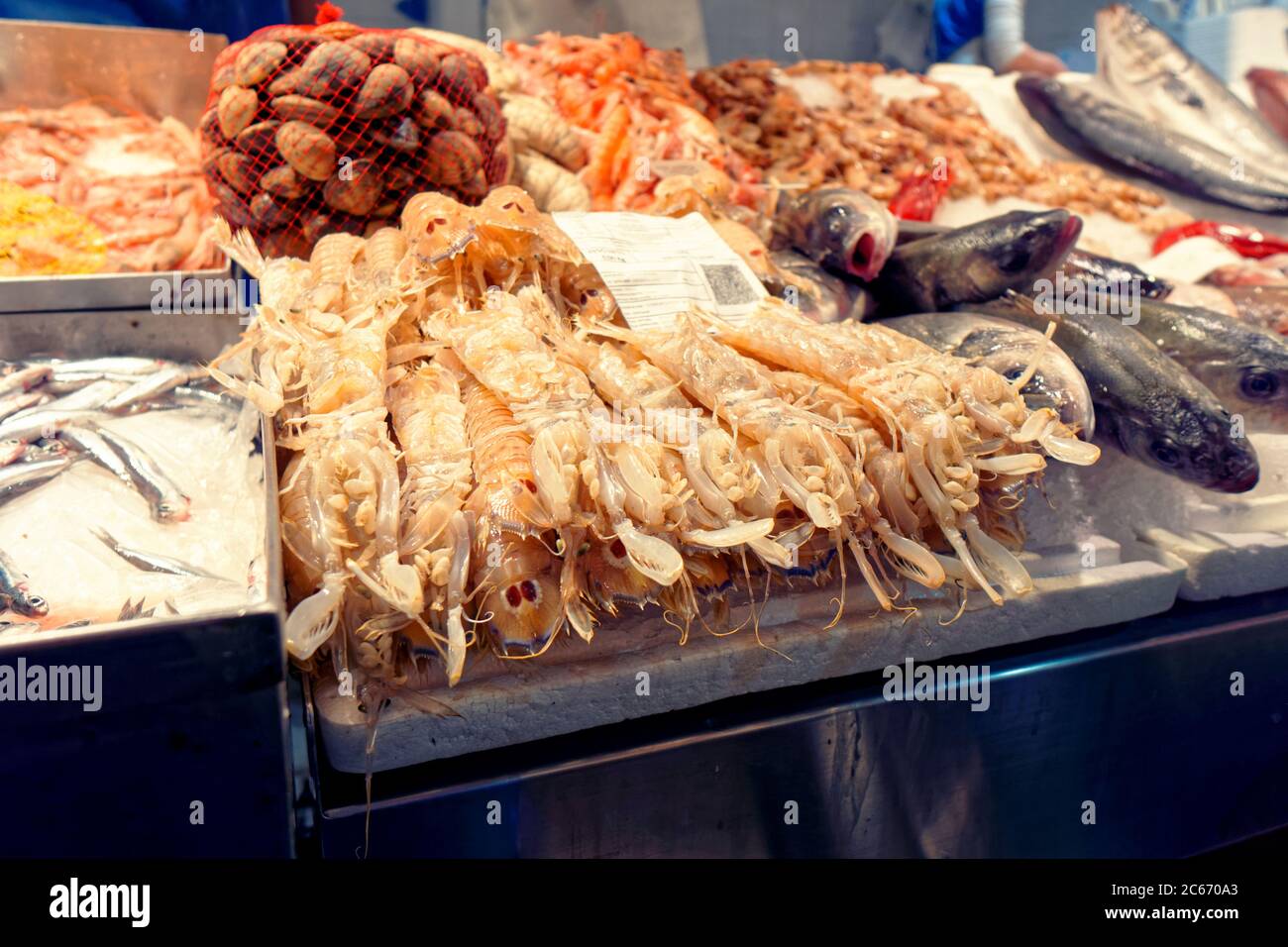 Mantis shrimps and fish on market display, toned Stock Photo - Alamy