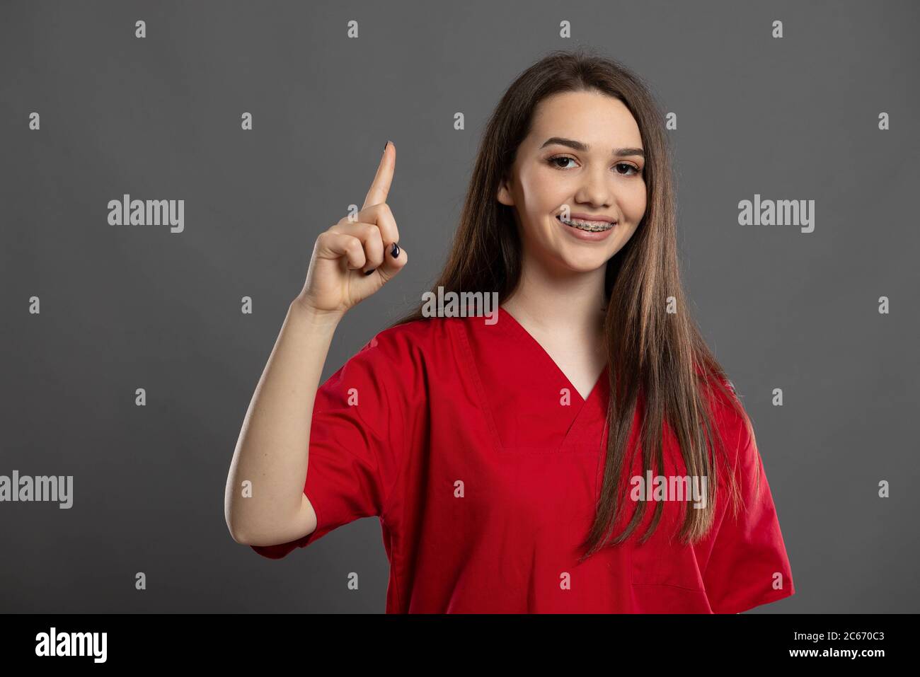 Young beautiful nurse counting to one on a black background Stock Photo ...