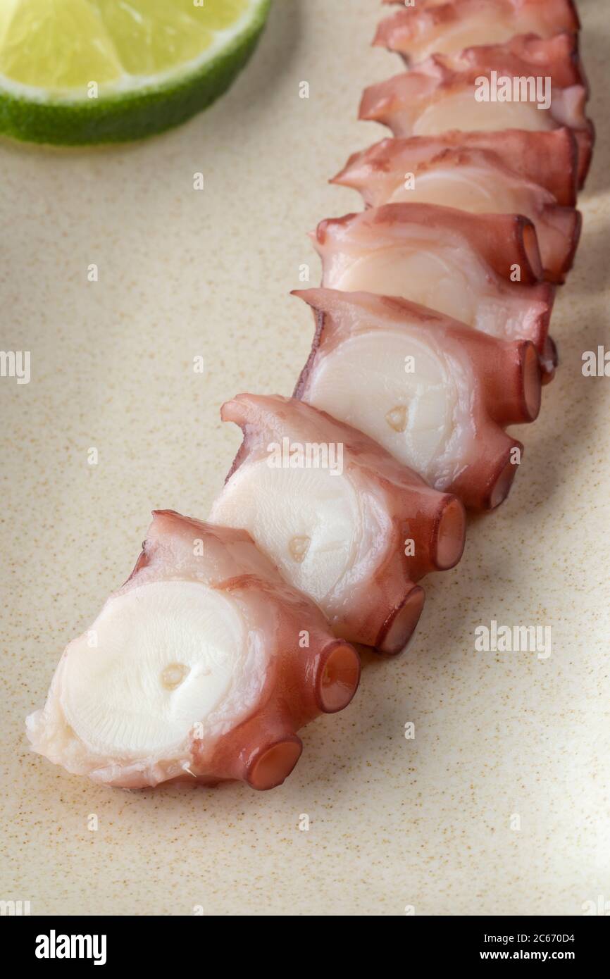 Fresh cooked octopus tentacle in slices close up Stock Photo - Alamy