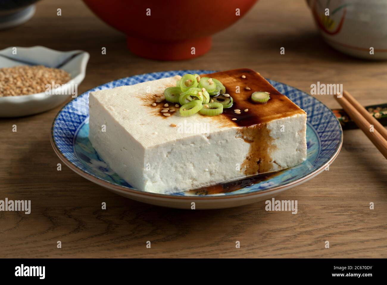 Piece of fresh white regular tofu in a Japanese bowl close up with ...