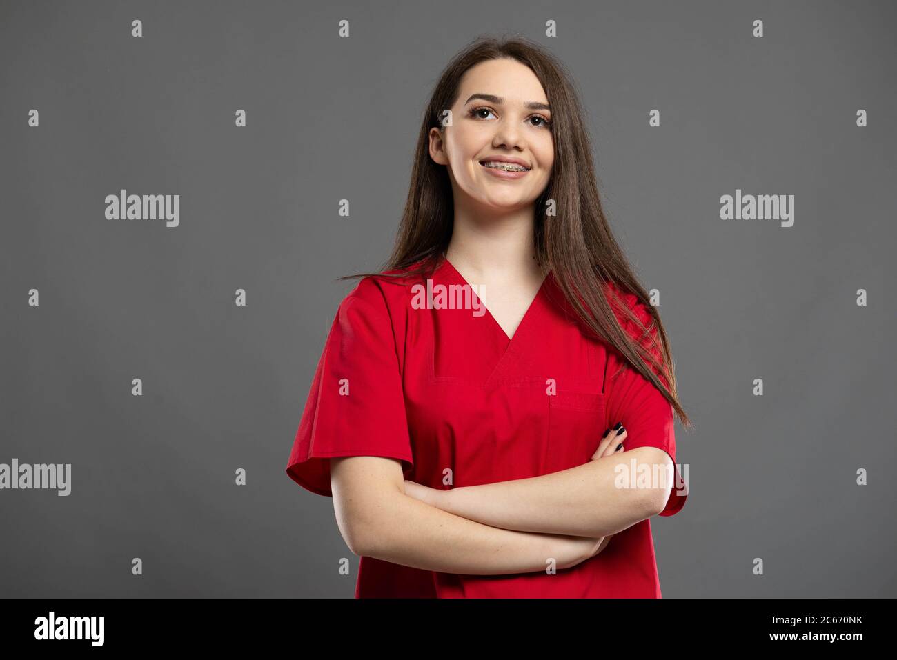 Heroshot of a beautiful young nurse showing confidence wearing red ...