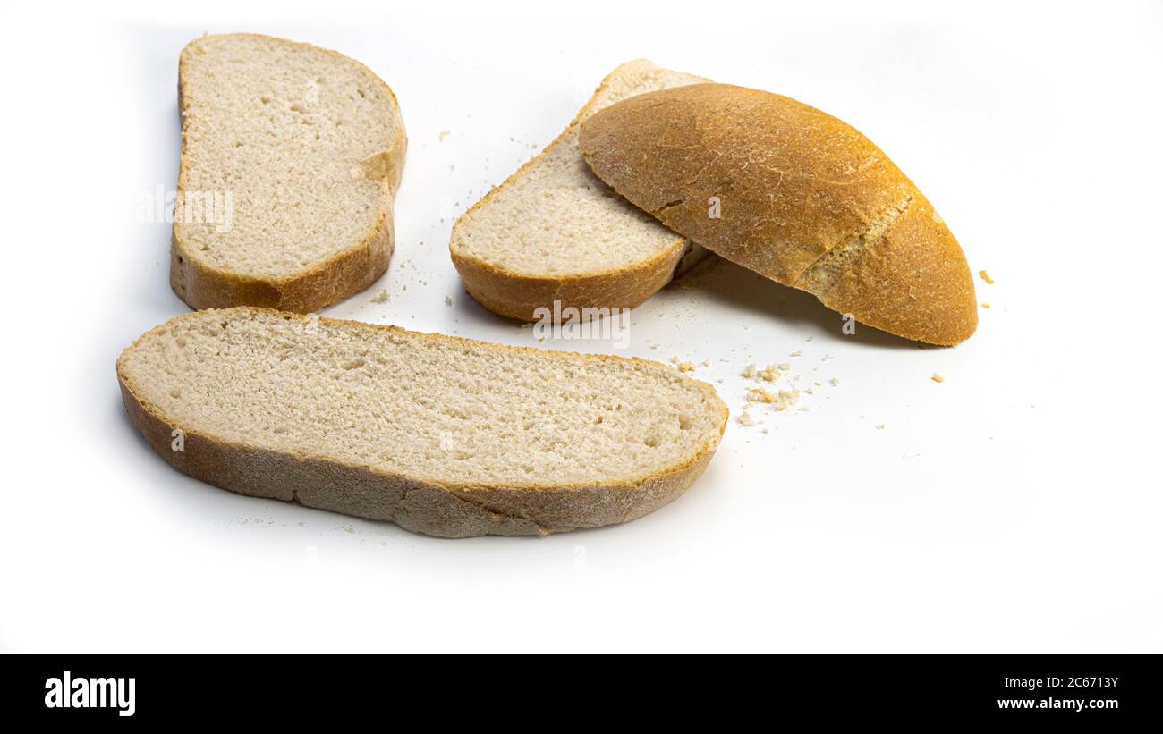 Wheat flour homemade round bread and slices of bread on a white ...