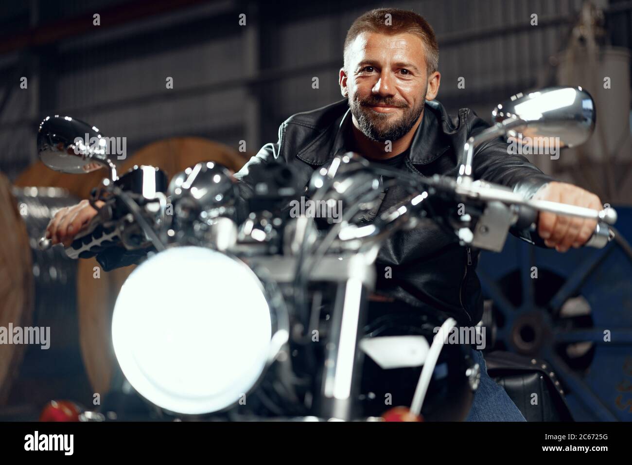 Man motorcyclist sitting on his motorbike in underground parking Stock ...