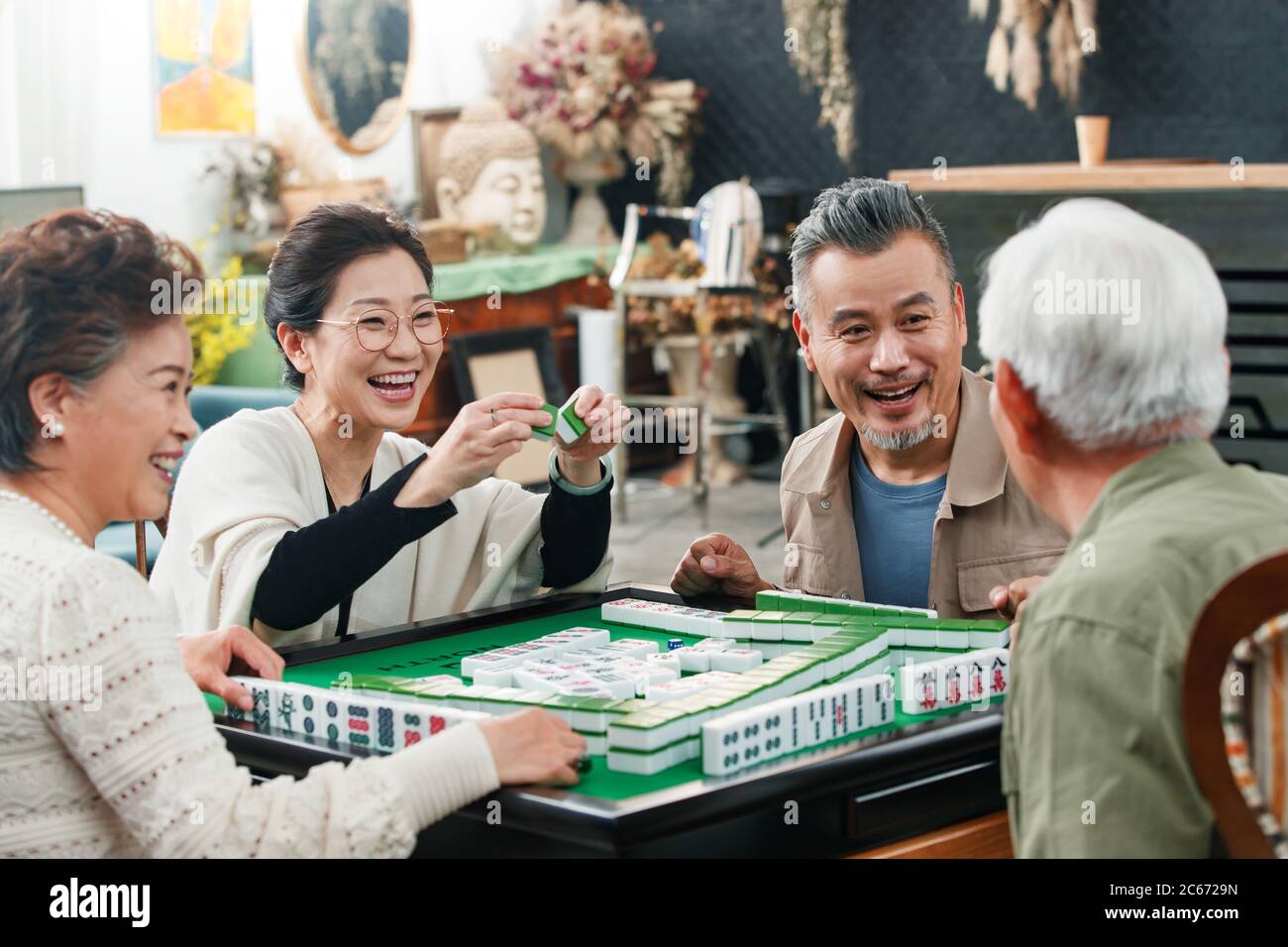 Happy old friends playing mahjong Stock Photo - Alamy