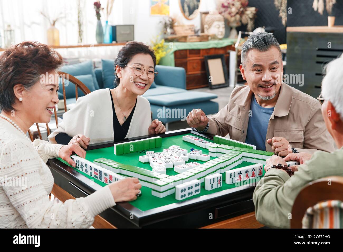 Happy old friends playing mahjong Stock Photo - Alamy