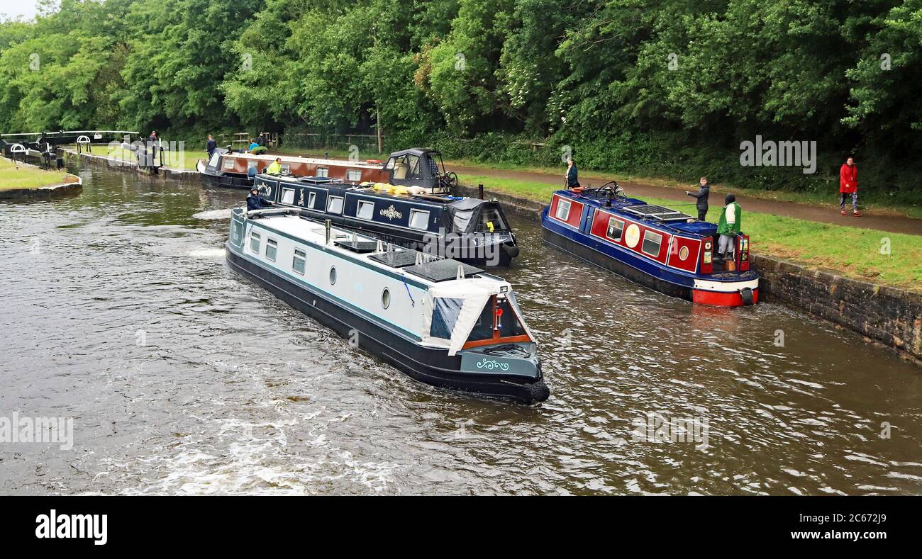 Four Narrow Boats working between Locks 76 and 75 on the Wigan flight ...