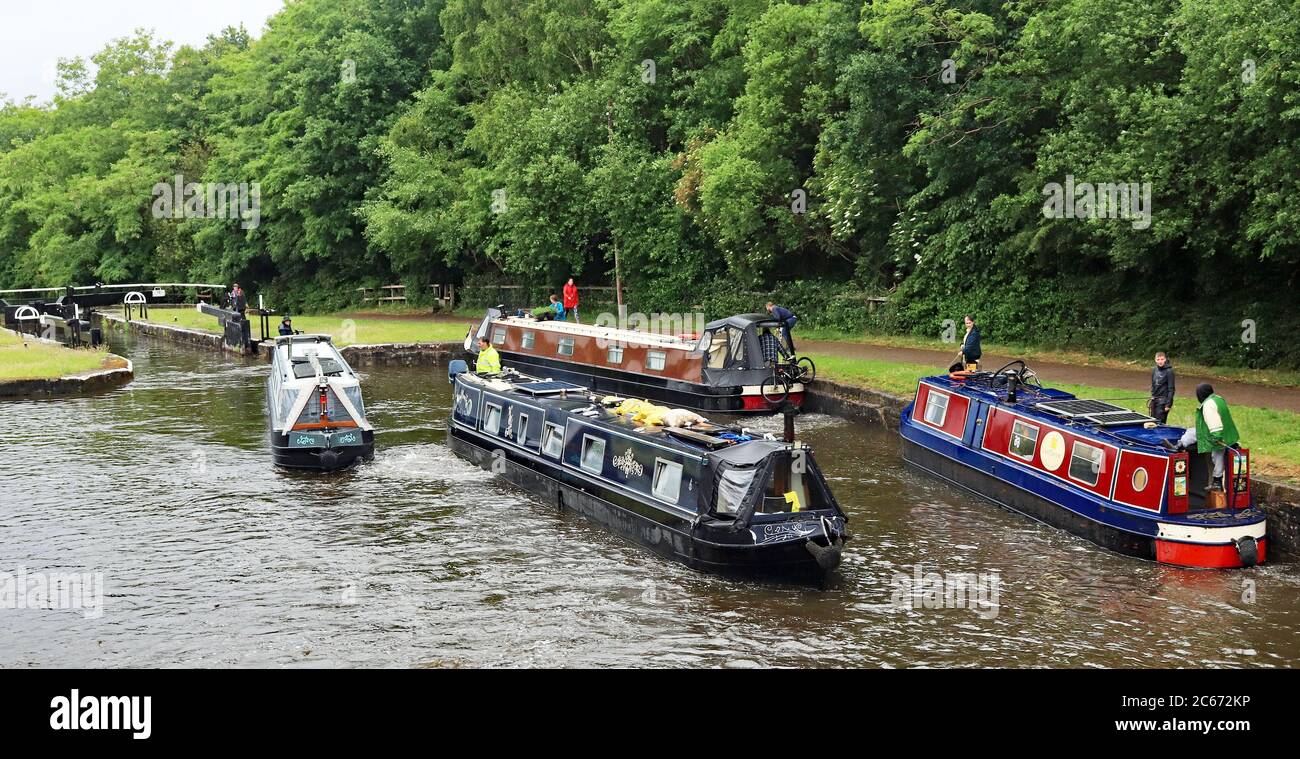 Four Narrow Boats working between Locks 76 and 75 on the Wigan locks ...
