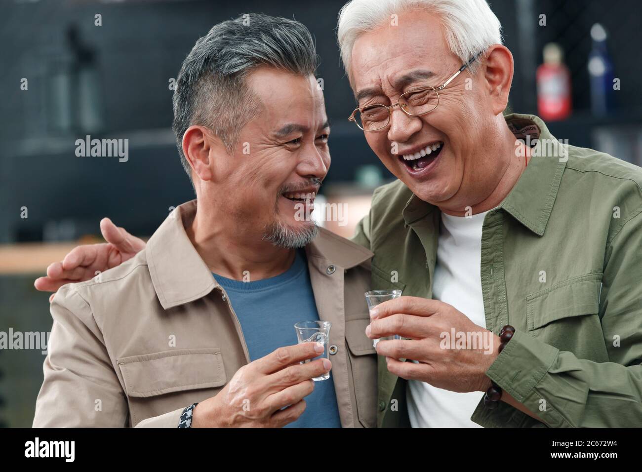 Happy old brothers to drink chat Stock Photo - Alamy