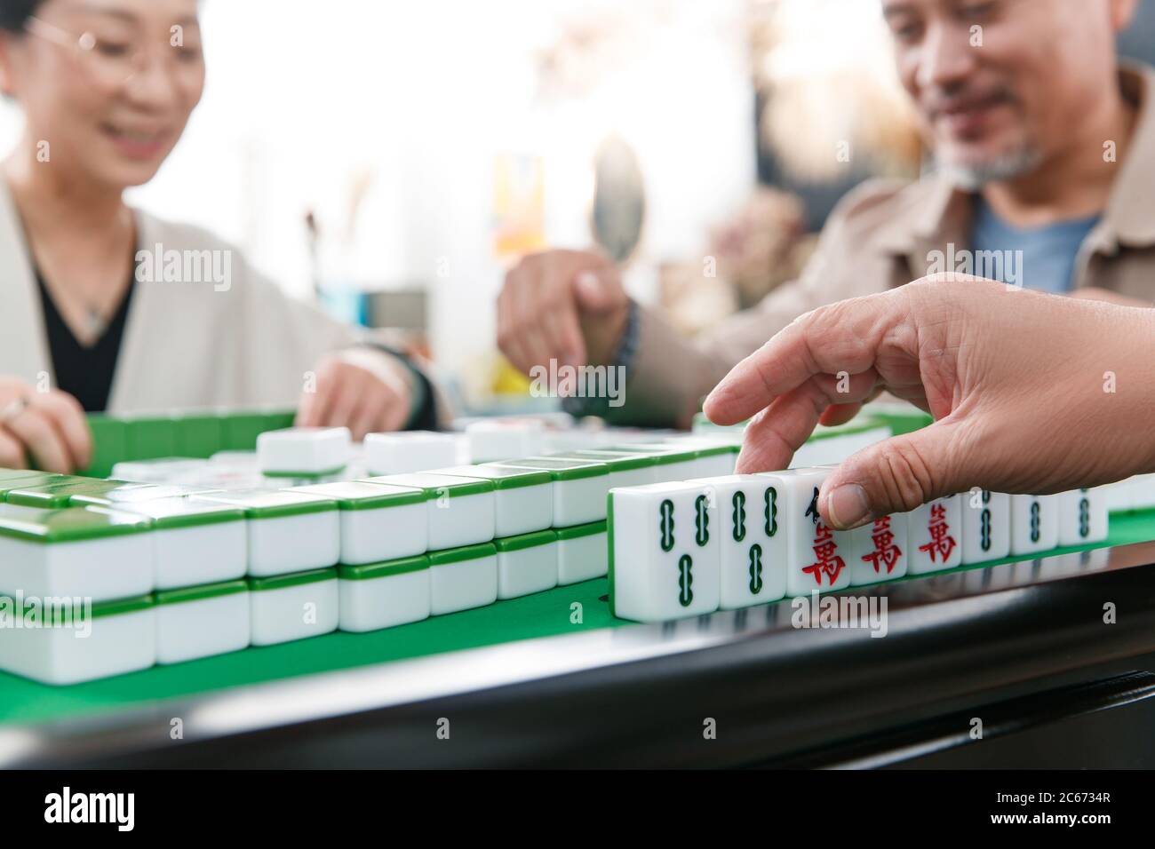 Happy old friends playing mahjong Stock Photo - Alamy