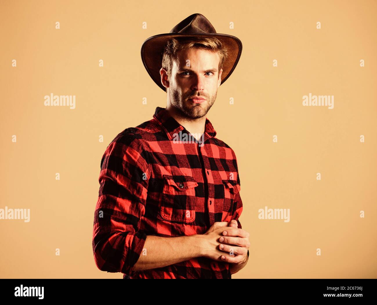 western fashion. wild west rodeo. Handsome man in hat. man checkered ...