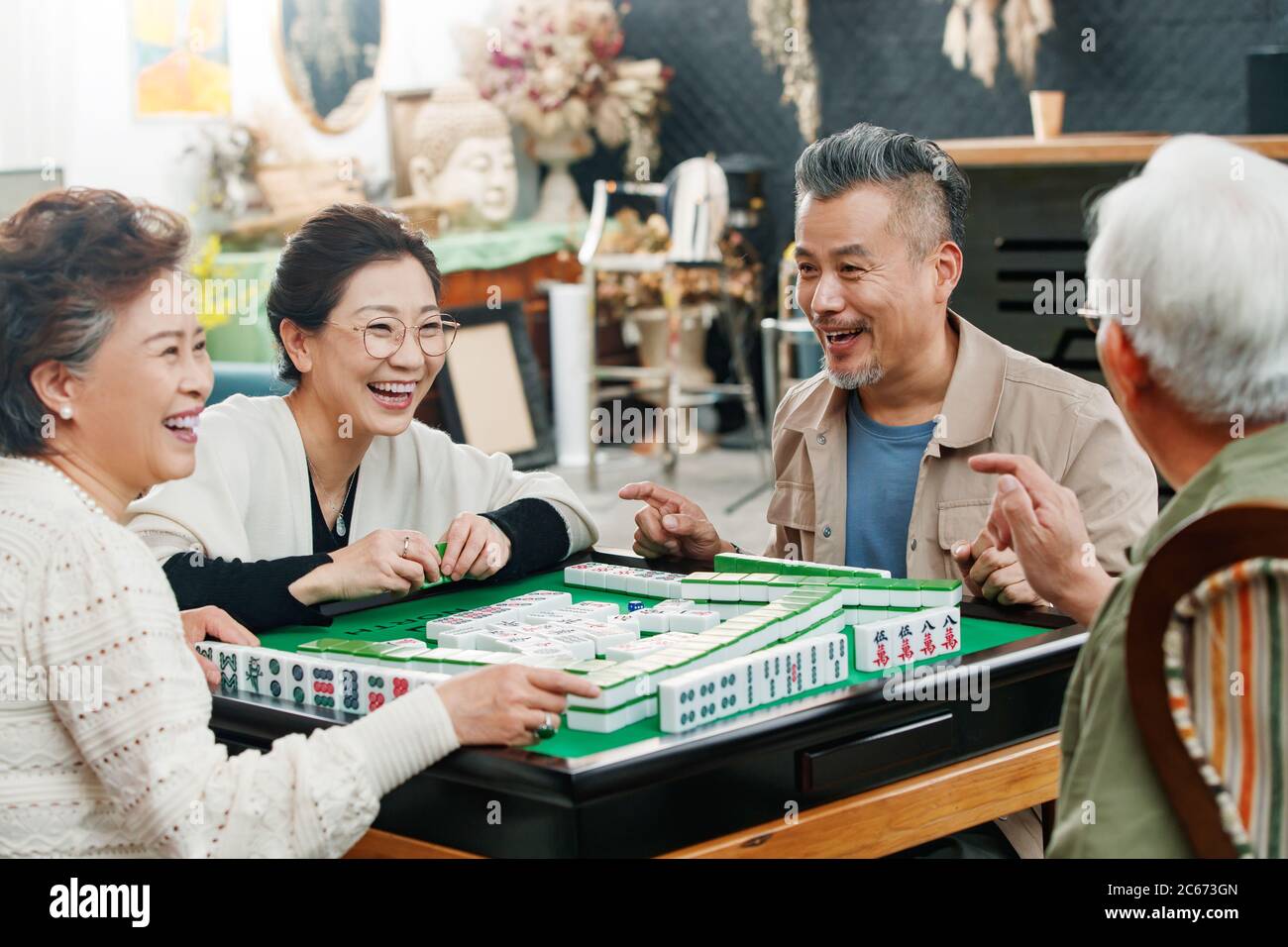 Happy old friends playing mahjong Stock Photo - Alamy