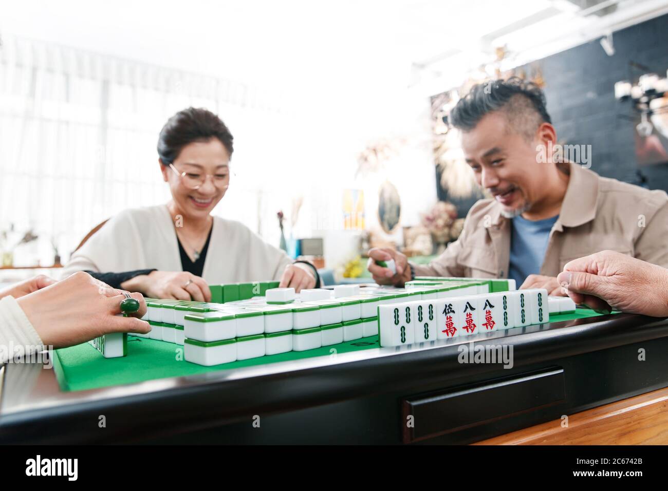 Happy old friends playing mahjong Stock Photo - Alamy
