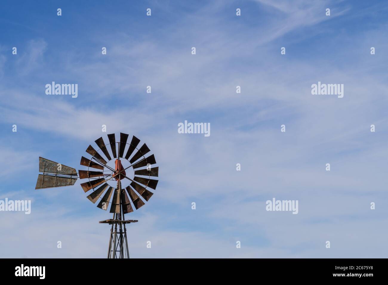 Retro/old-fashioned wind turbines in field Stock Photo - Alamy