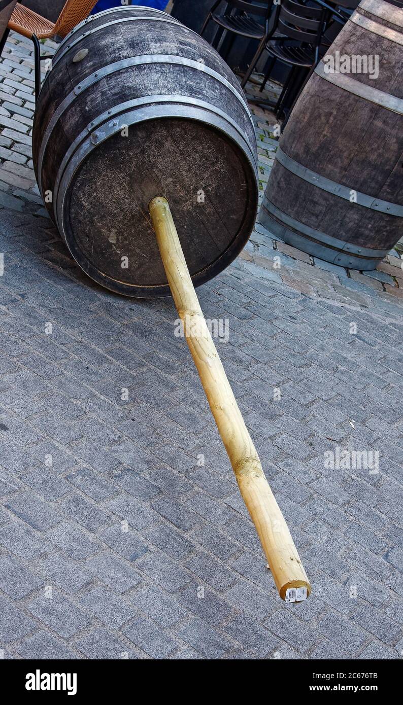 rotating a barrel, wood pole, wine production, cobblestones, alcoholic ...