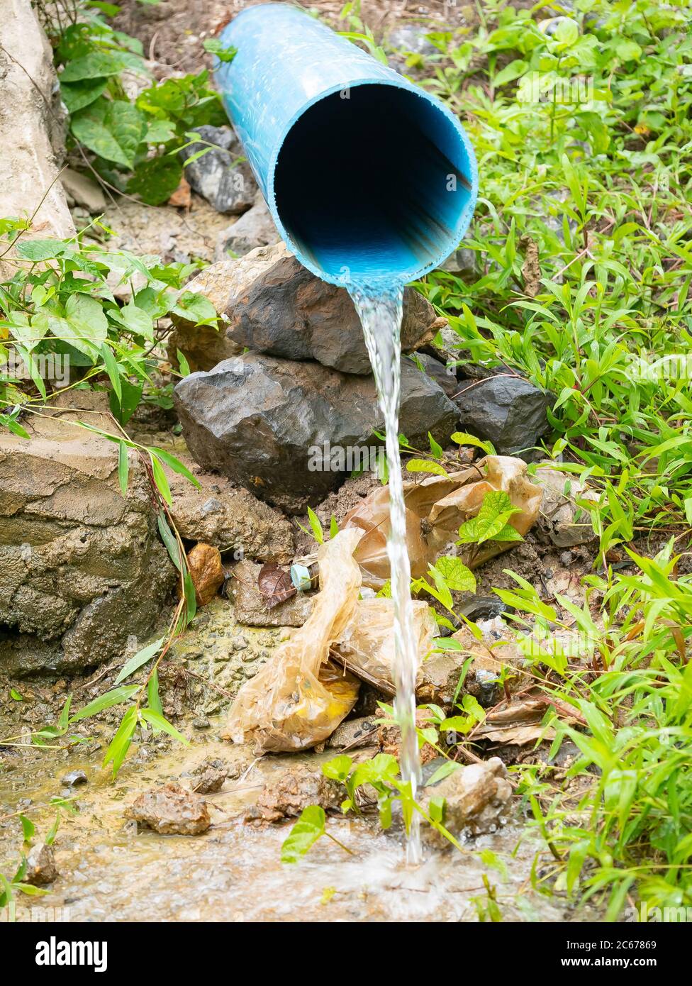 Waste water flowing from blue pipe background Stock Photo - Alamy