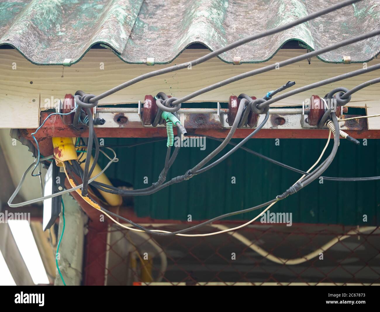 high voltage power lines under roof building Stock Photo - Alamy