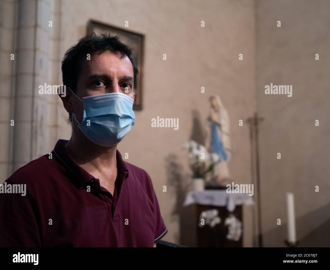 horizontal portrait of a man wearing a surgical mask standing and ...