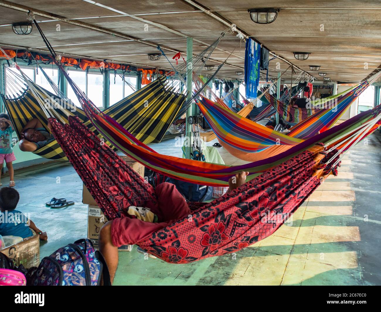 Amazon River, Peru - Sep 19, 2019: People on the hammocks on the cargo ...