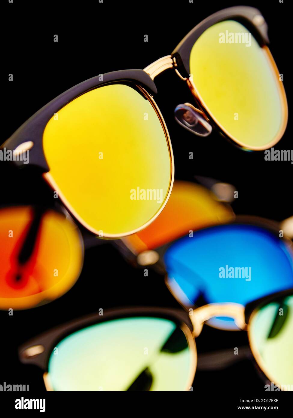 Sunglasses with colorful lenses on black background Stock Photo - Alamy