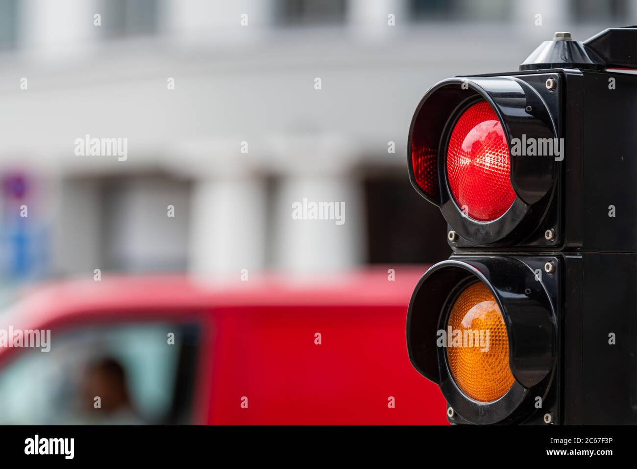 traffic control semaphore with stop light on a defocused city ...