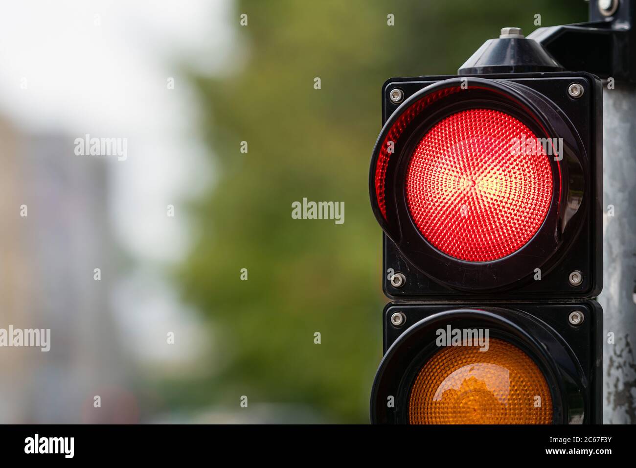 traffic control semaphore with stop light on a defocused city ...