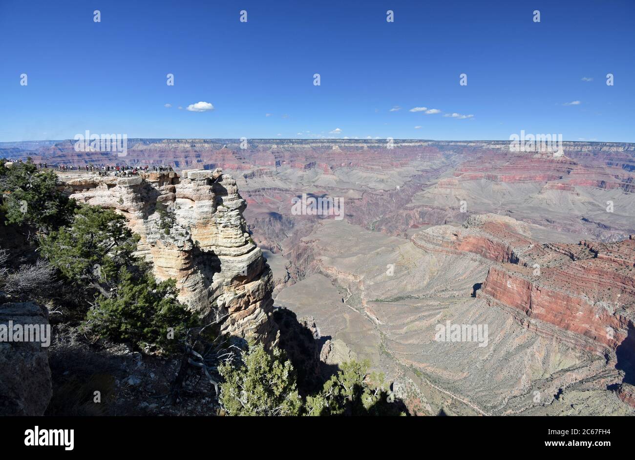 Mather point is seen sticking out into the Grand Canyon. Visitors seen ...