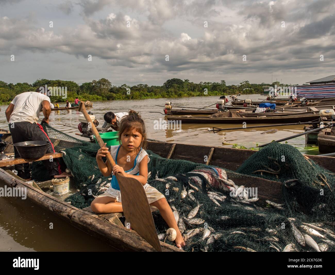 Amazon river, Peru- December 11, 2017: Small peruvian girl is sitting ...