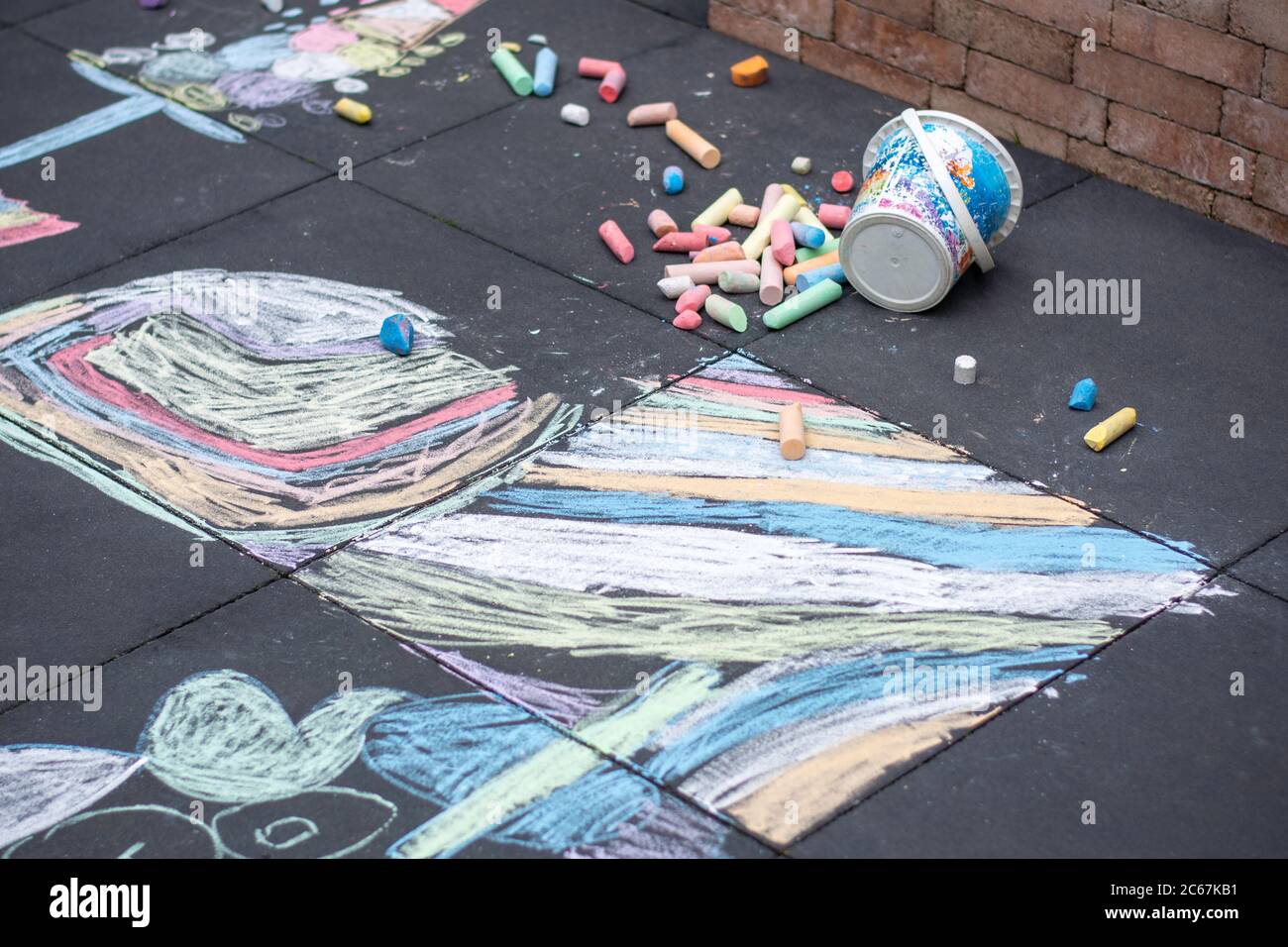 Large colored street chalk. Plastic bucket with sidewalk chalk with ...