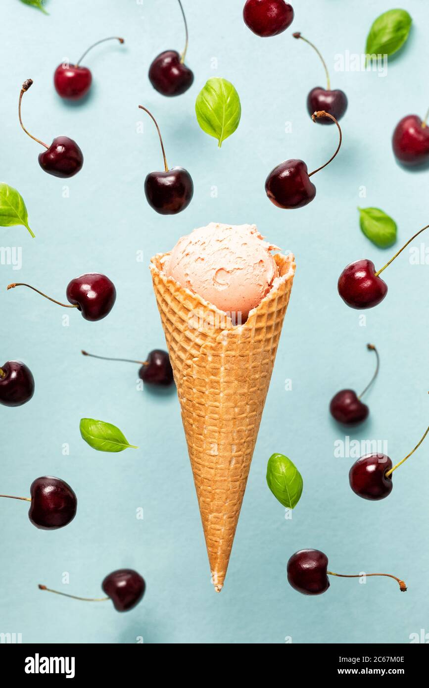 Flying strawberry and basil ice cream cone in motion Stock Photo - Alamy