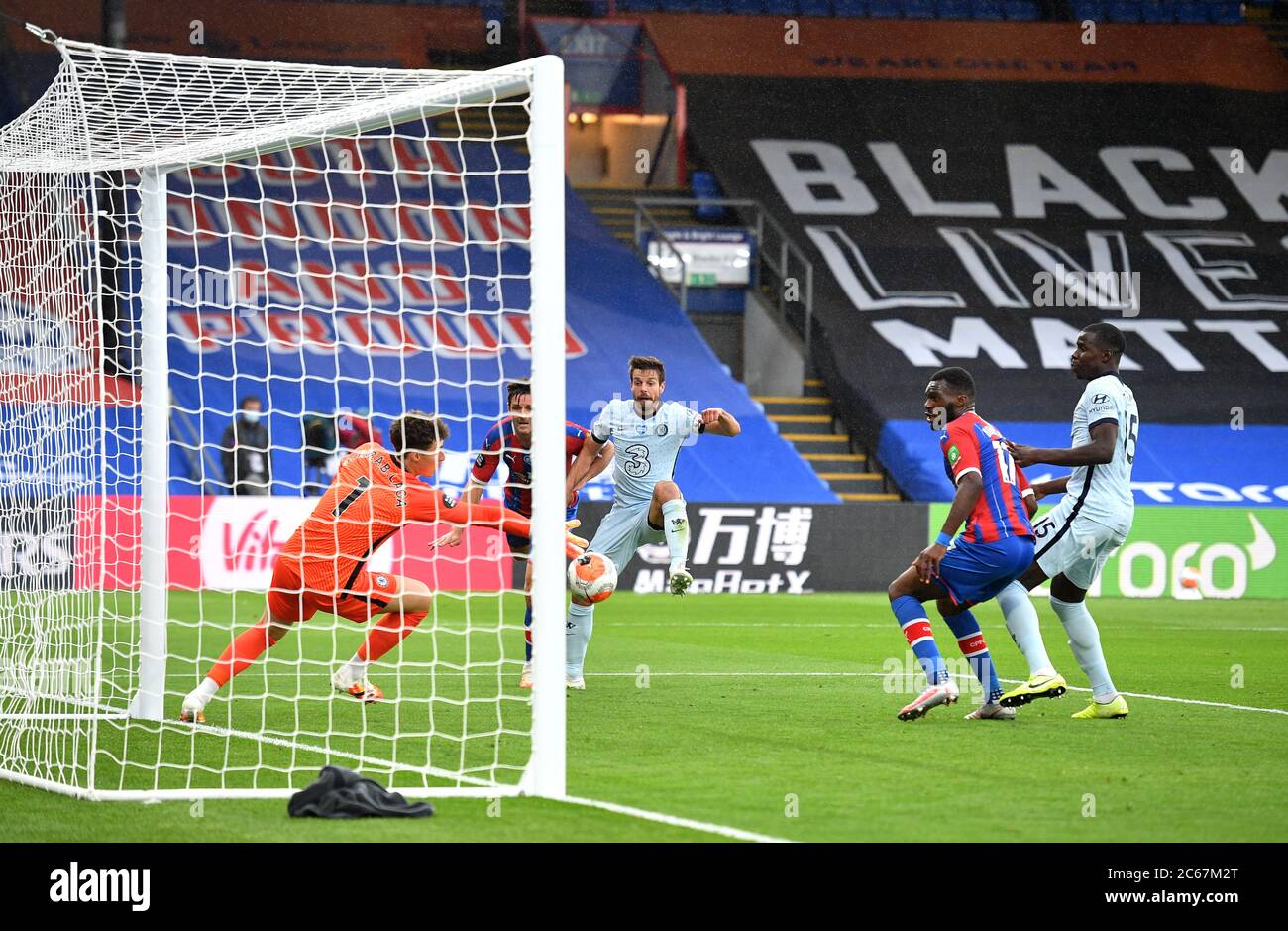 Chelsea goalkeeper Kepa Arrizabalaga (left) saves from Crystal Palace's ...