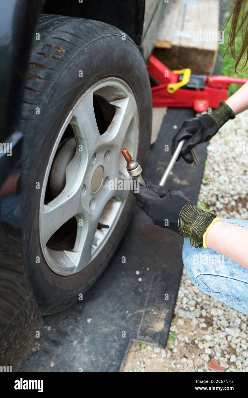 Woman changing tire hi-res stock photography and images - Alamy