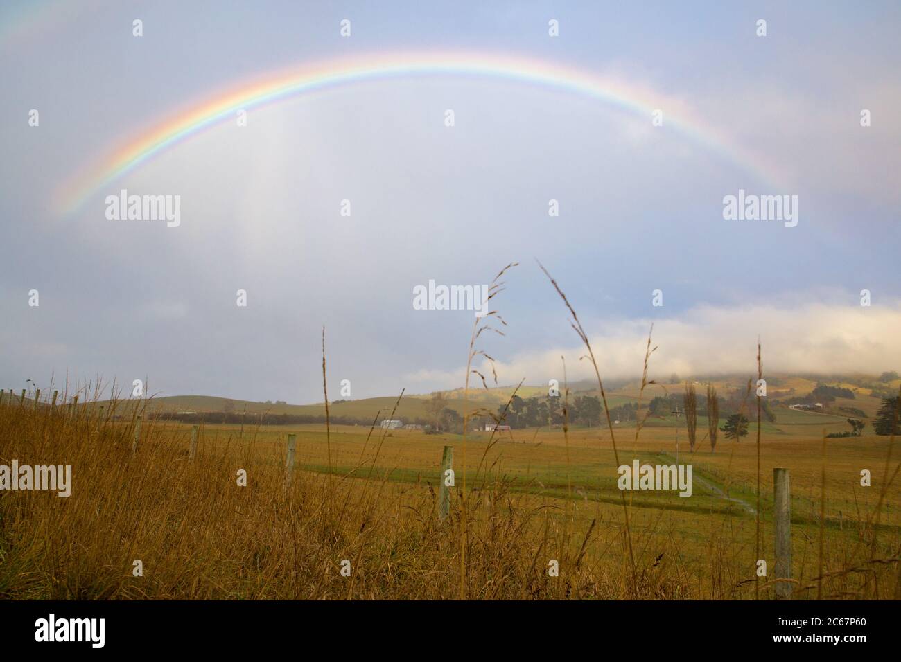 The sun breaks through the drizzly day bringing a gorgeous rainbow to ...
