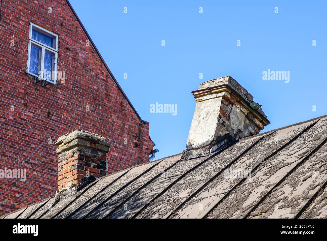 damaged brick chimney, cracked and dangerously tilted Stock Photo - Alamy