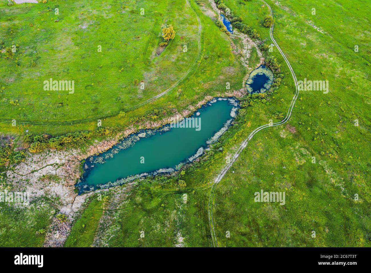 Aerial landscape of blue lake in green field, top view of beautiful ...
