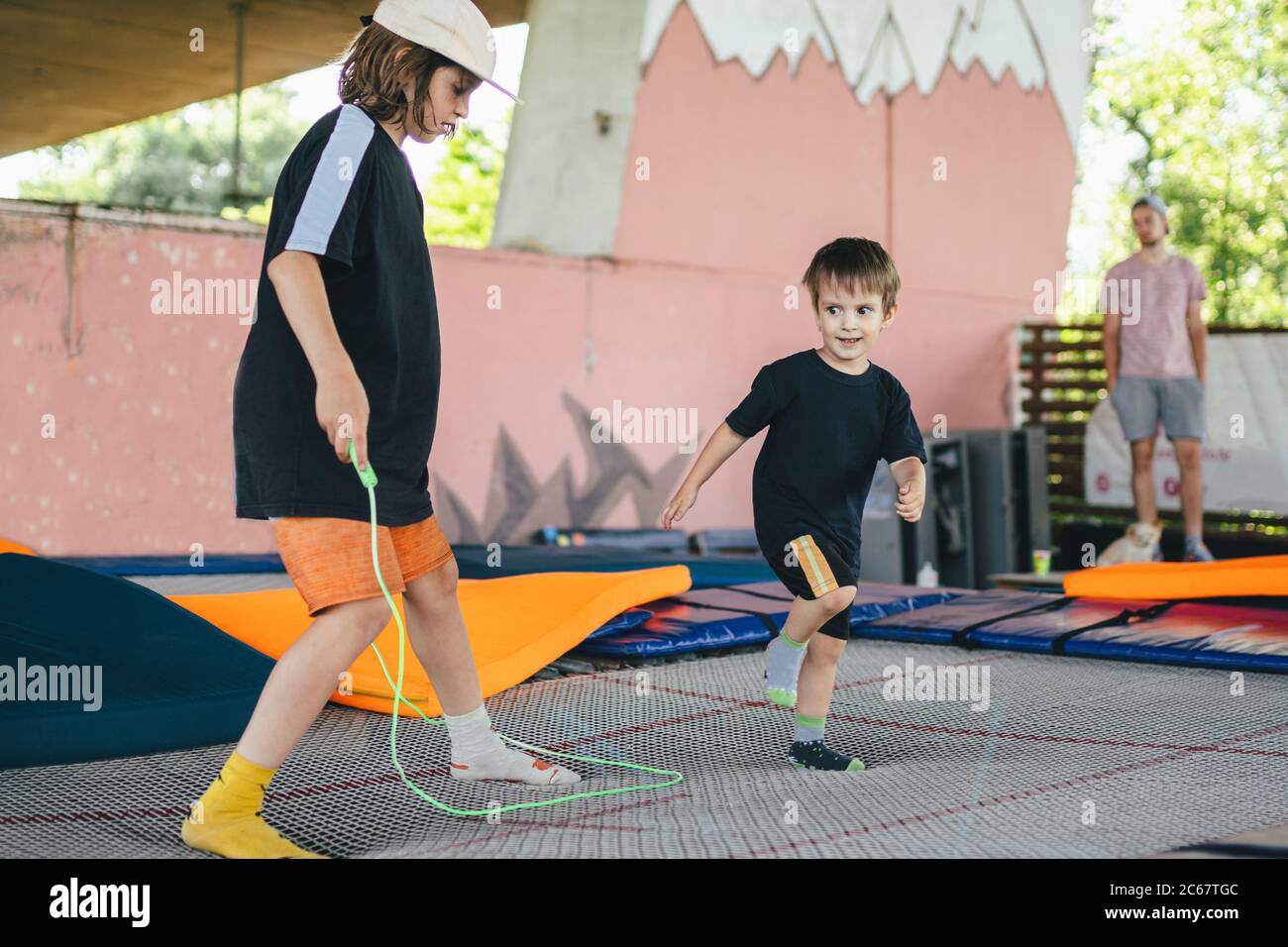 Two little boys jumping on trampoline in sport center. Kids having fun ...