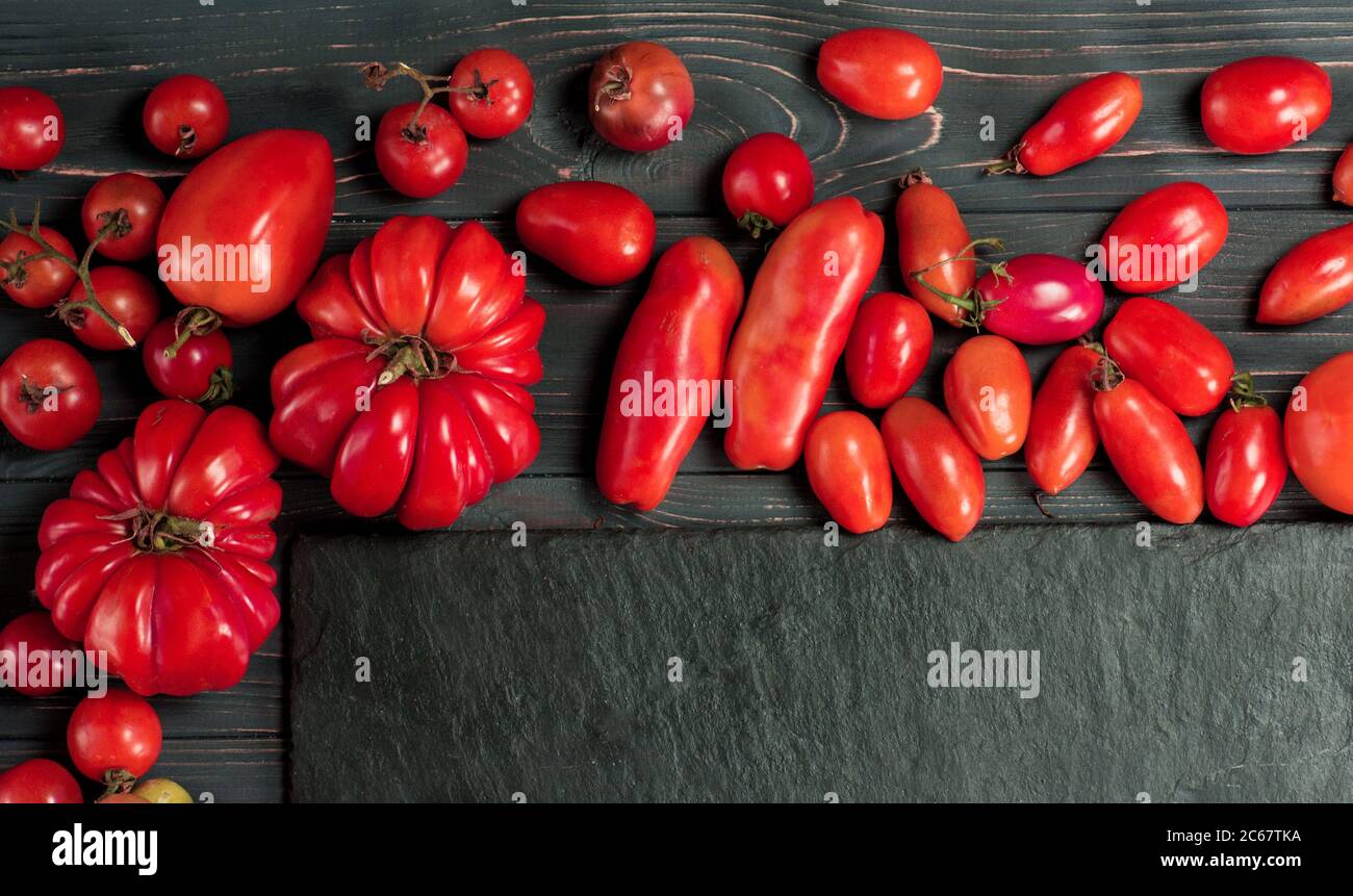 Mix tomatoes background. Several varieties of tomatoes on summer day ...
