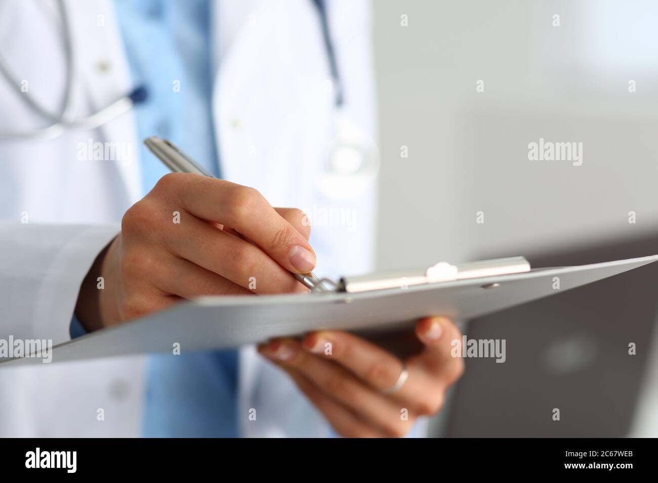 Doctor doing a survey and filling out a medical form Stock Photo - Alamy