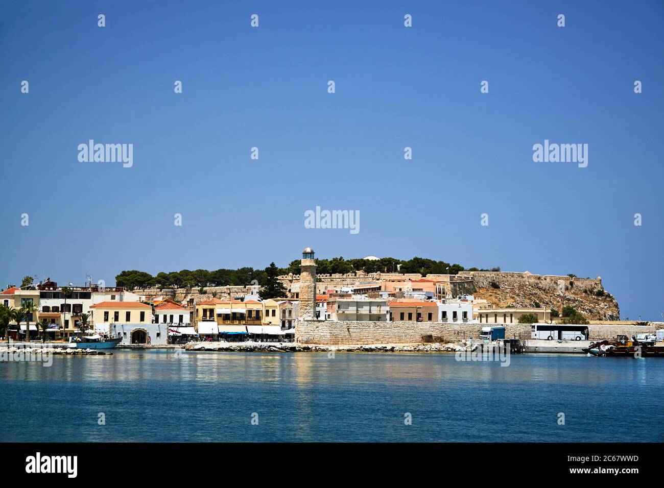 stone wall and historic lighthouse in the port of Rethymnon on the ...