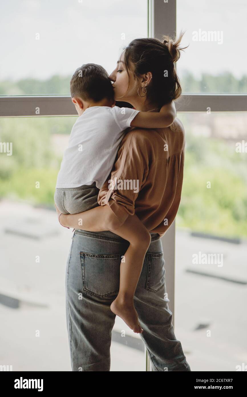 Beautiful young mother holding child in her arms Stock Photo - Alamy Beautiful young mother holding child in her arms Stock Photo - Alamy