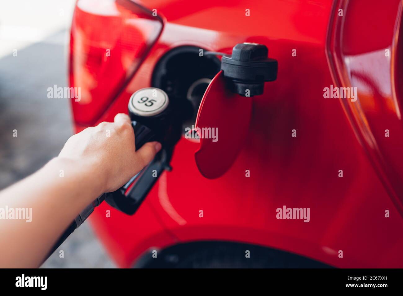 Woman pumping gas fuel into car at filling station. Petrol station ...