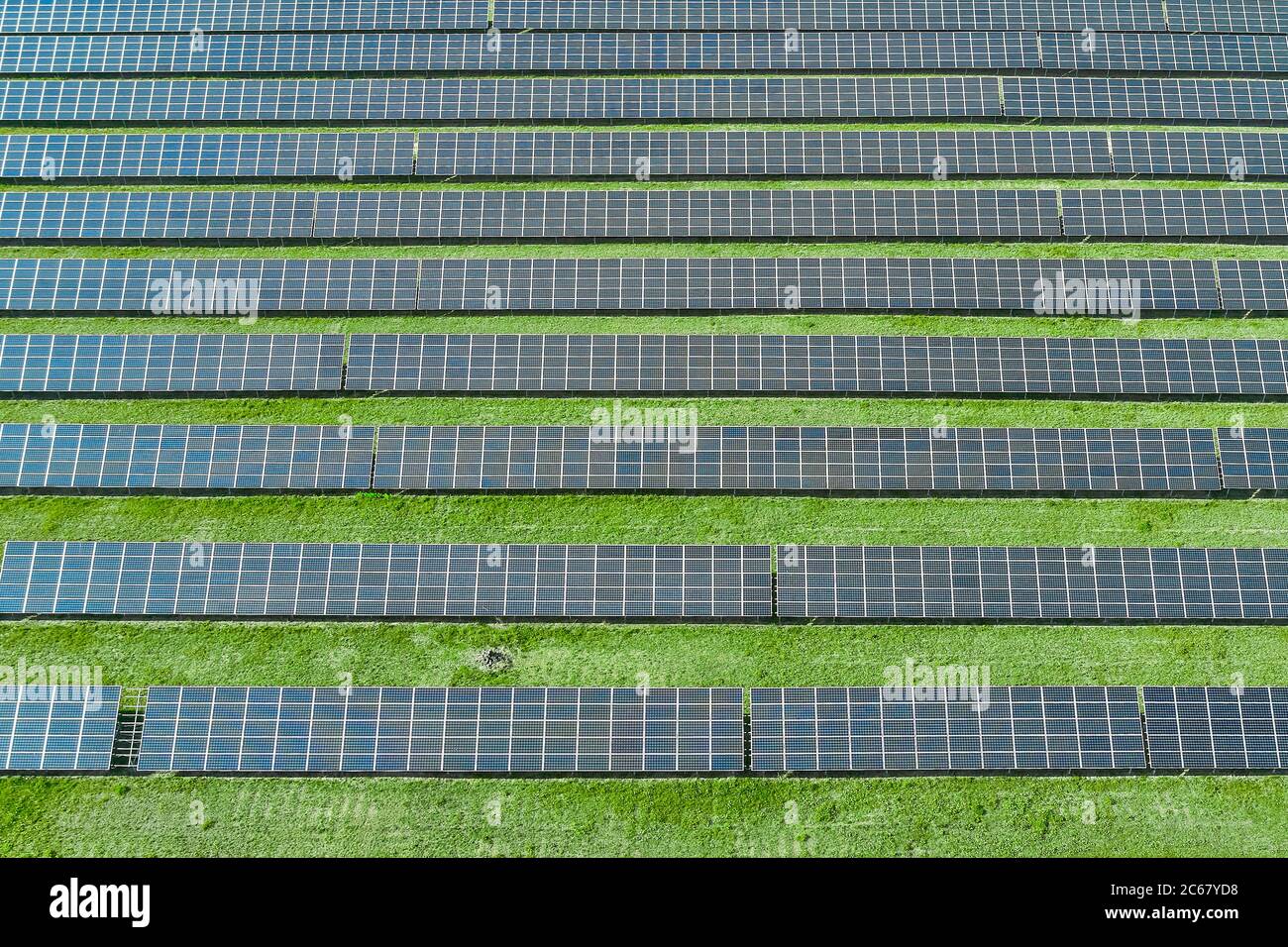 Aerial view of horizontal solar panel in the field with green grass ...