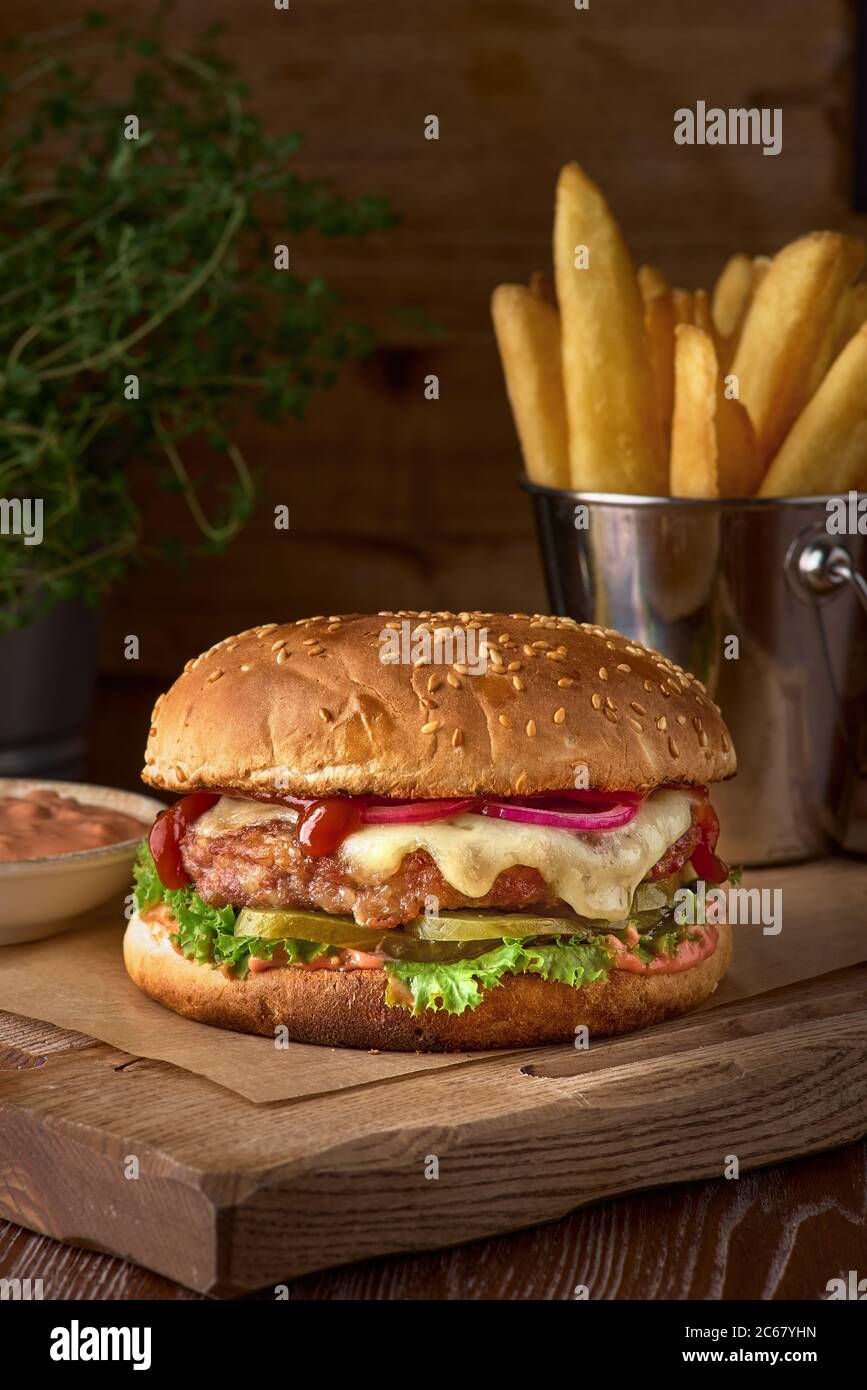 Fast food dish. Appetizing meat burgers, potato chips and vegetable ...