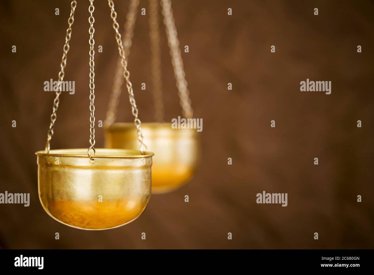 Business balance concept, gold weighing scales on brown background ...