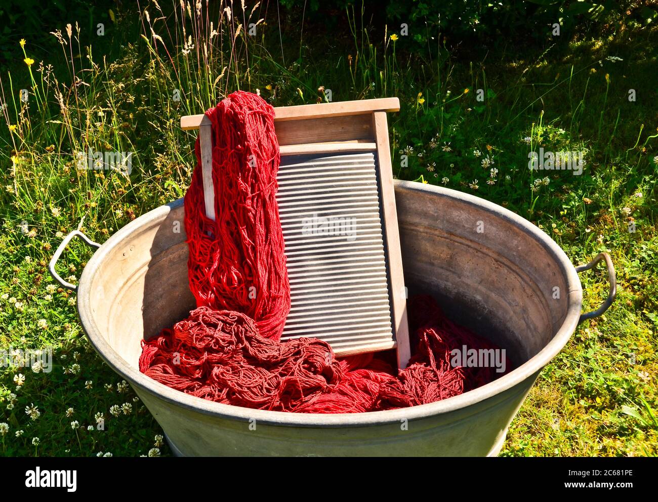 An old fashioned washing trougth filled with dyed and washed strings ...