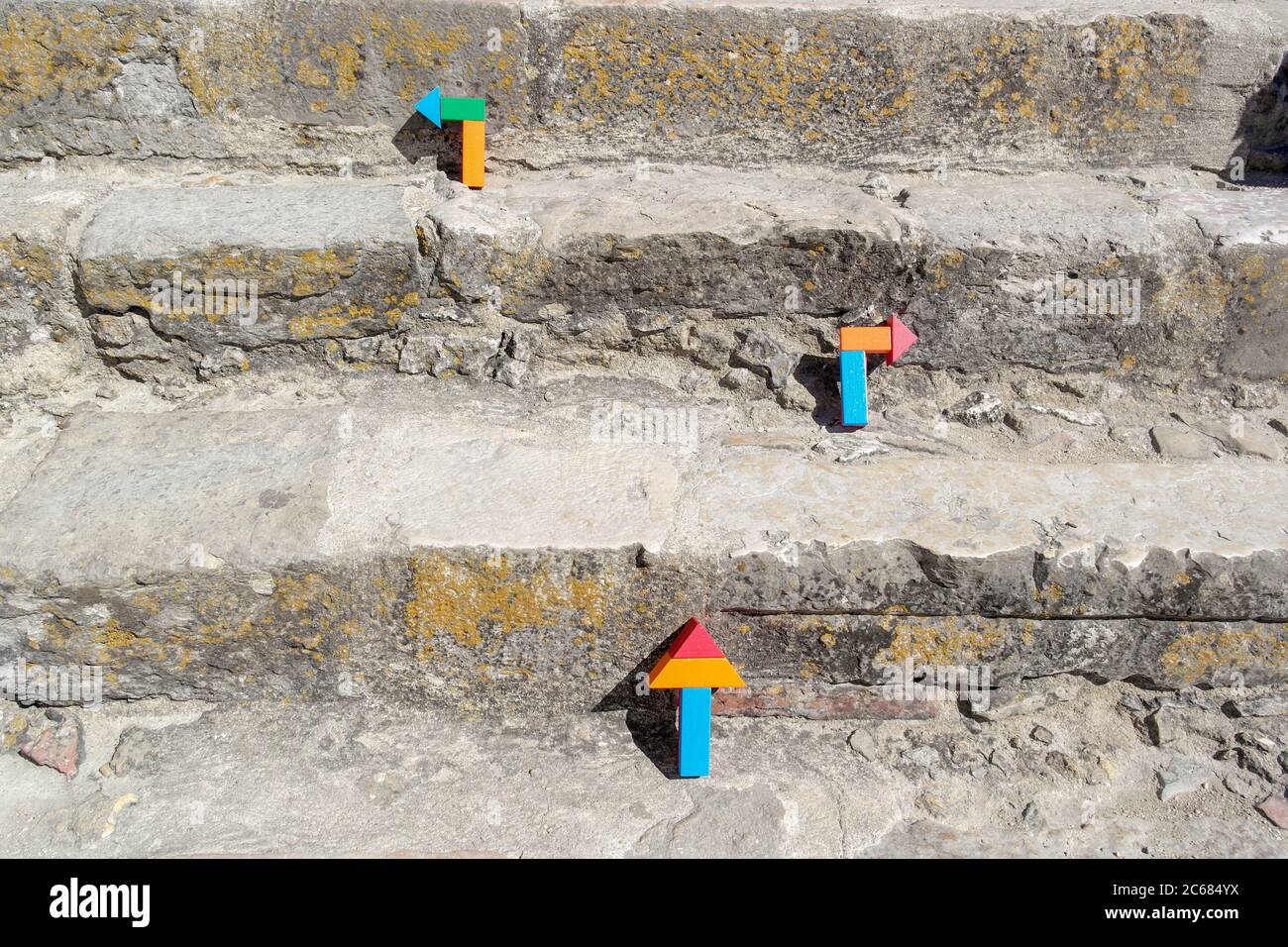 Detail of some arrows with a stone wall background Stock Photo - Alamy