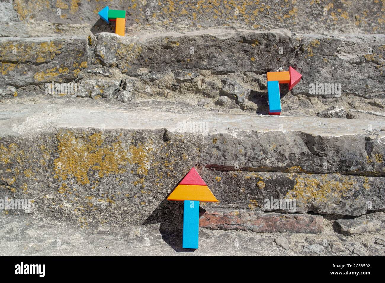 Detail of some arrows with a stone wall background Stock Photo - Alamy