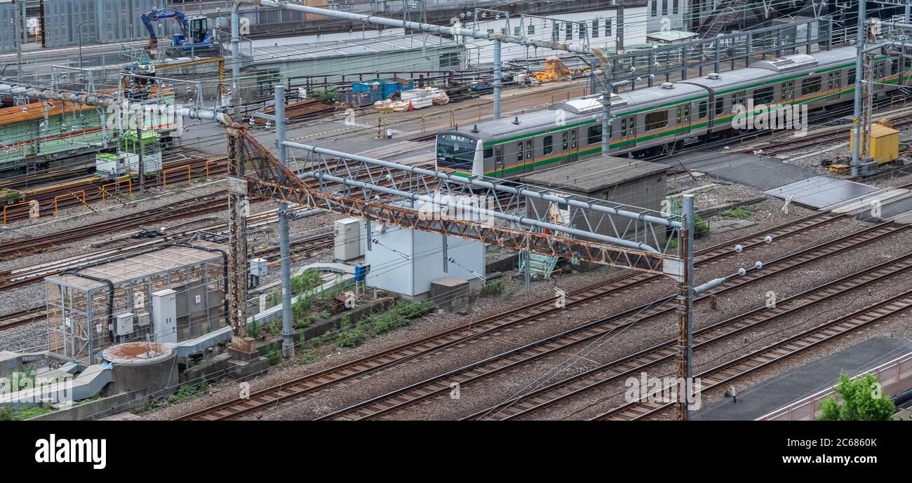 Commuter train traveling on its track at Tokyo Railway Station, Japan ...