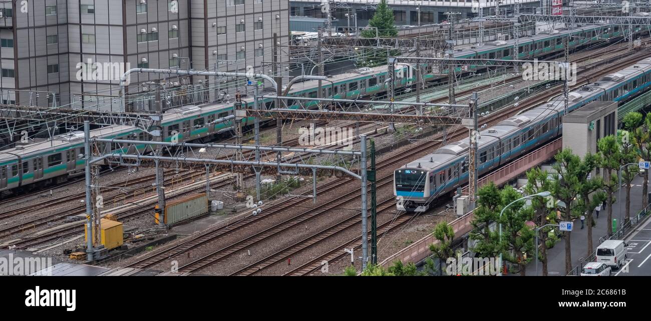 Commuter train traveling on its track at Tokyo Railway Station, Japan ...