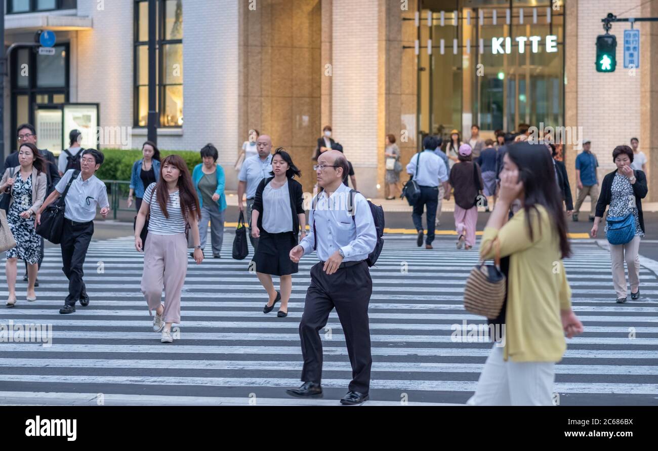 Pedestrian crossing the street at Kitte Shopping complex, Tokyo, Japan ...